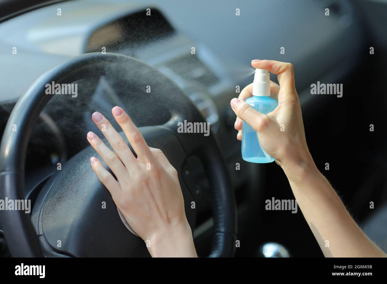 Hand of woman is spraying alcohol,disinfectant spray in car,safety ...