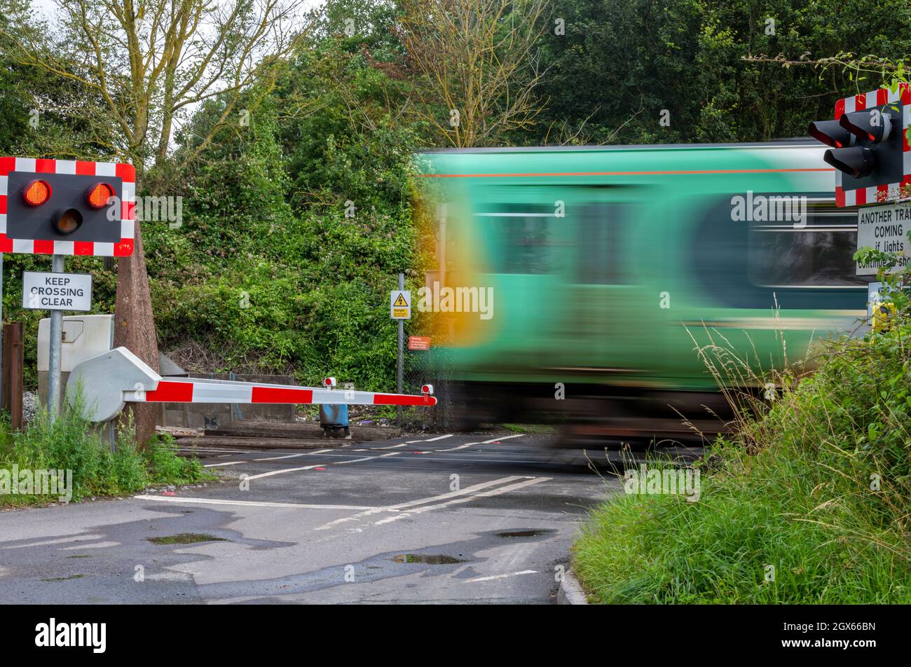 train going over an automatic half barrier level crossing on the ... train going over an automatic half barrier level crossing on the ...