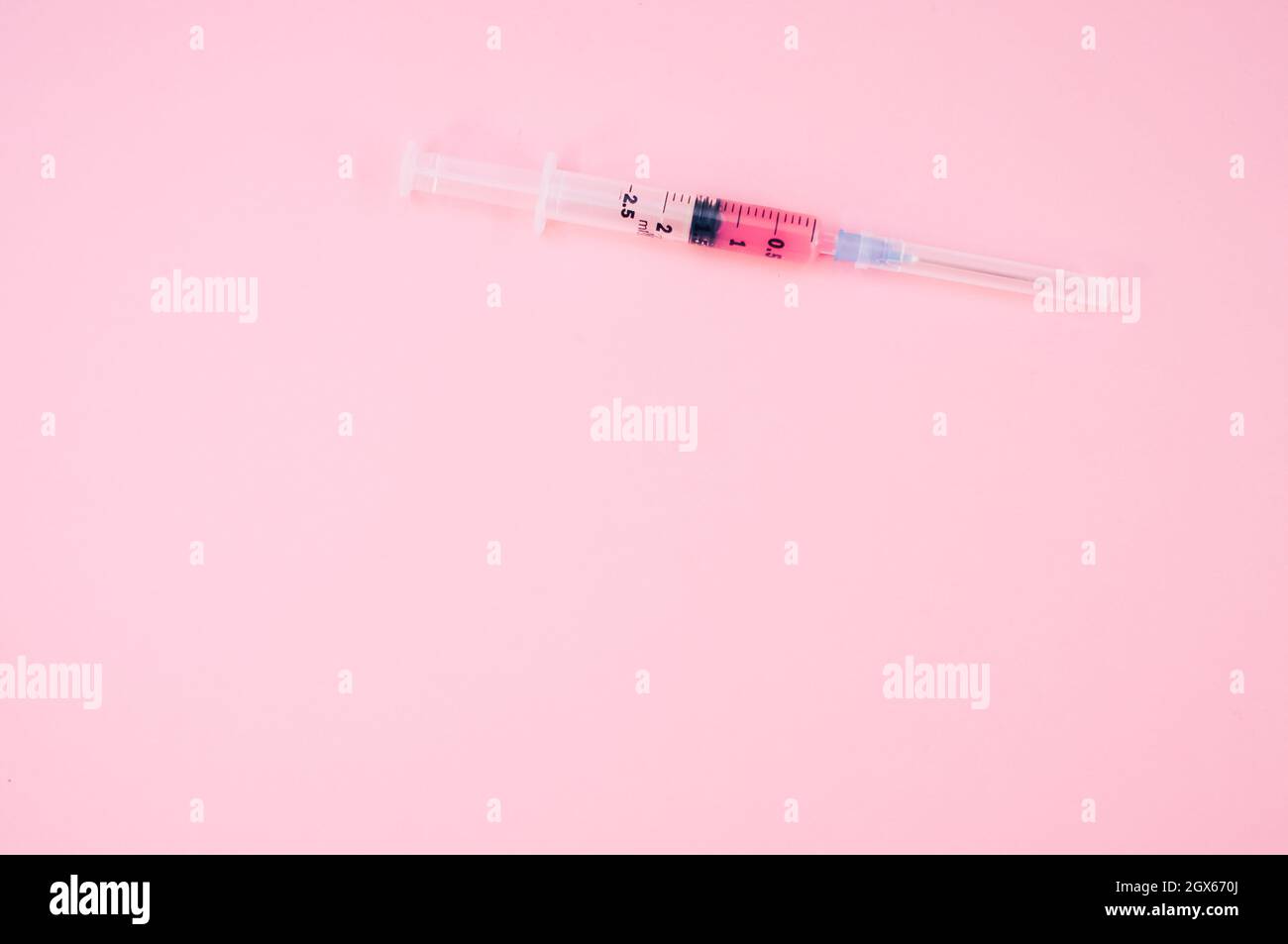 isolated sterilized injection syringe on a pink background Stock Photo ...