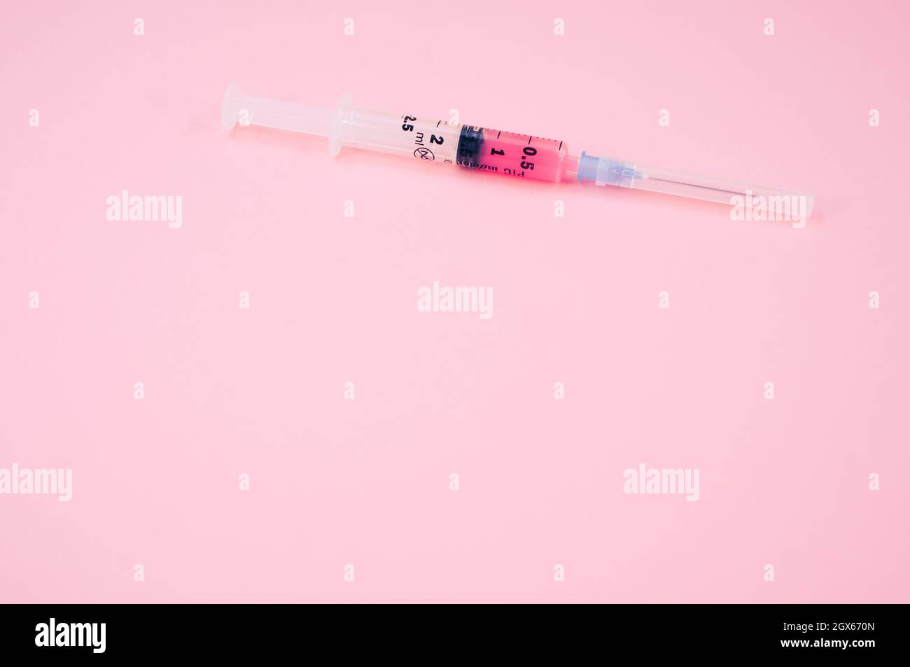 isolated sterilized injection syringe on a pink background Stock Photo ...