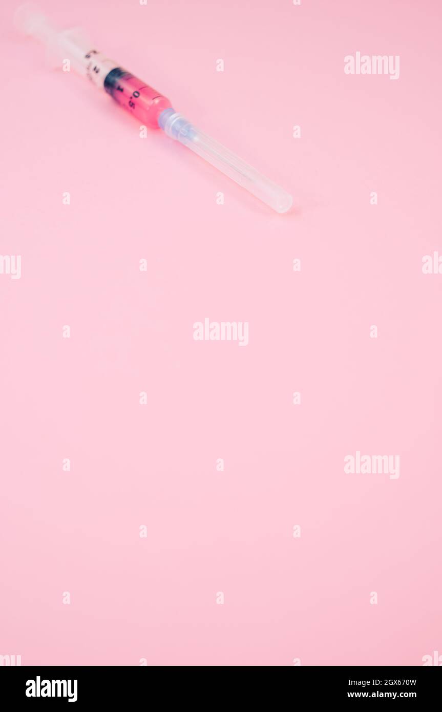 isolated sterilized injection syringe on a pink background Stock Photo ...