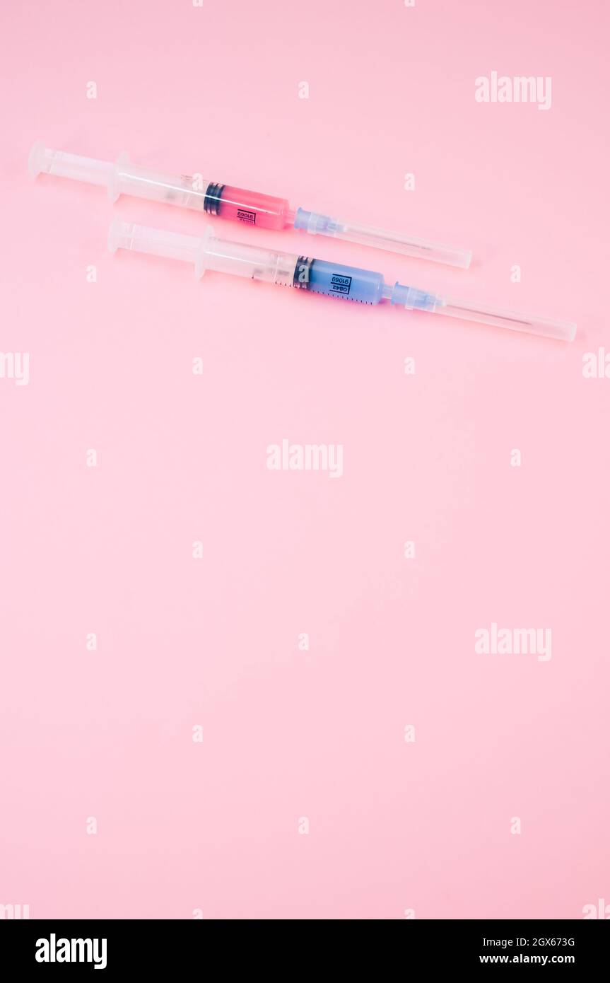 isolated sterilized injection syringe on a pink background Stock Photo ...