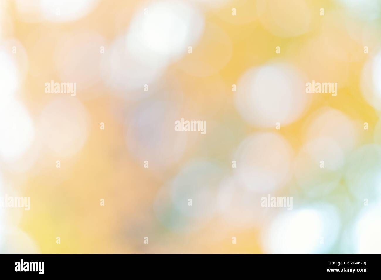 Abstract yellow warm colors background with bokeh defocused lights and ...