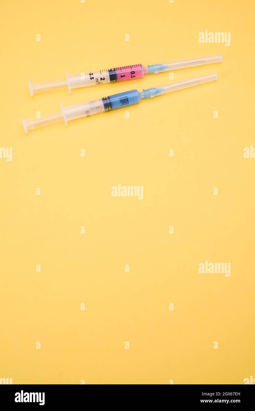 isolated sterilized injection syringe on a yellow background Stock ...
