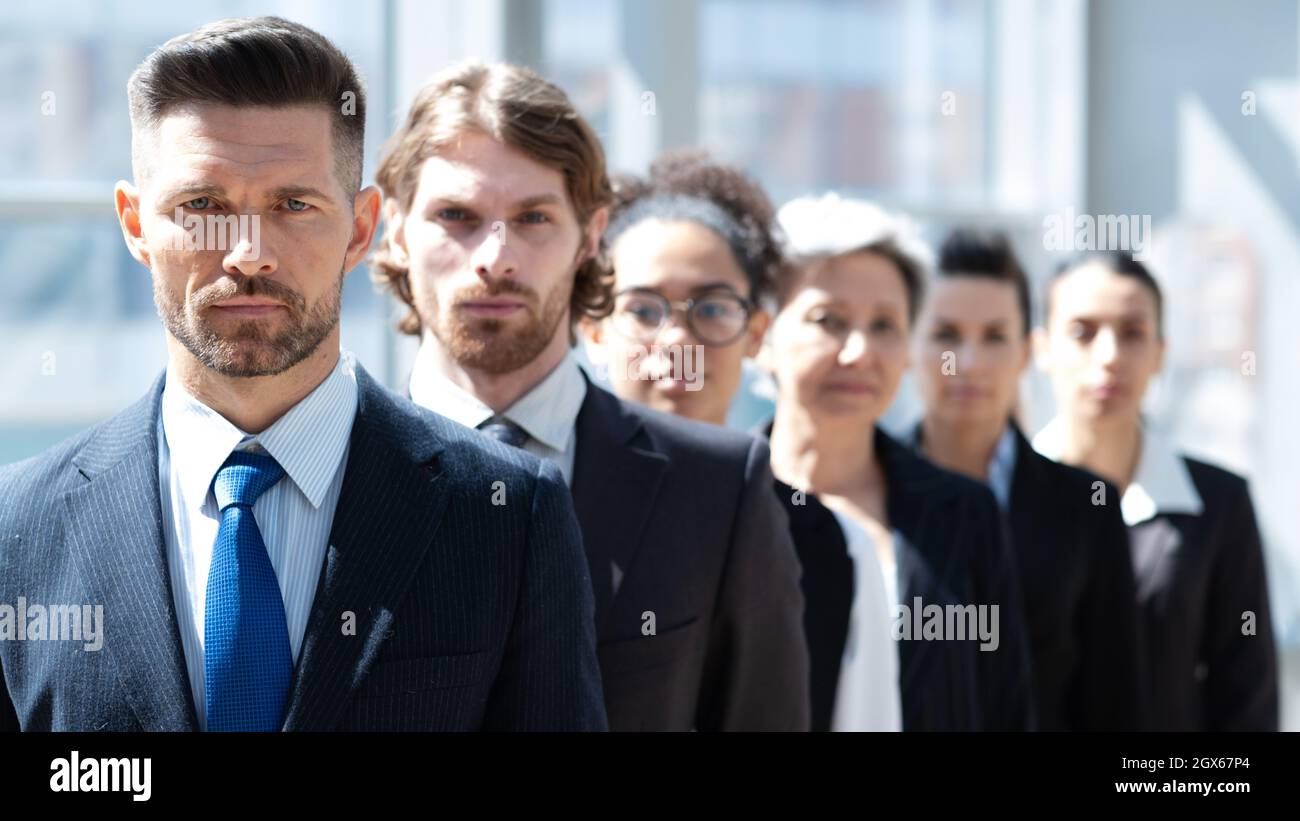 Multi ethnic group of business people standing in a row in modern ...
