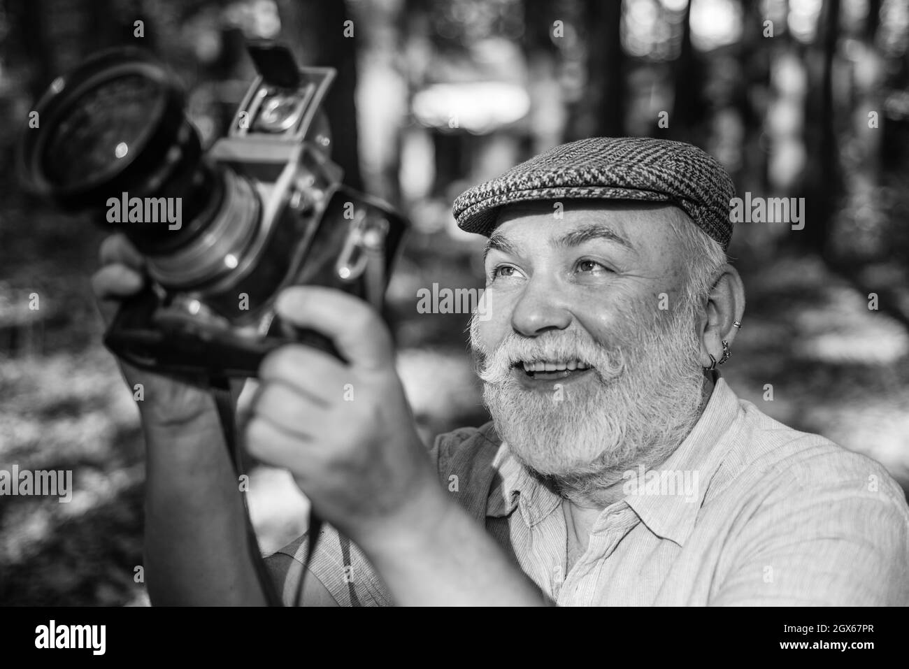 Old camera man summer outdoor. active senior man make photo of nature ...