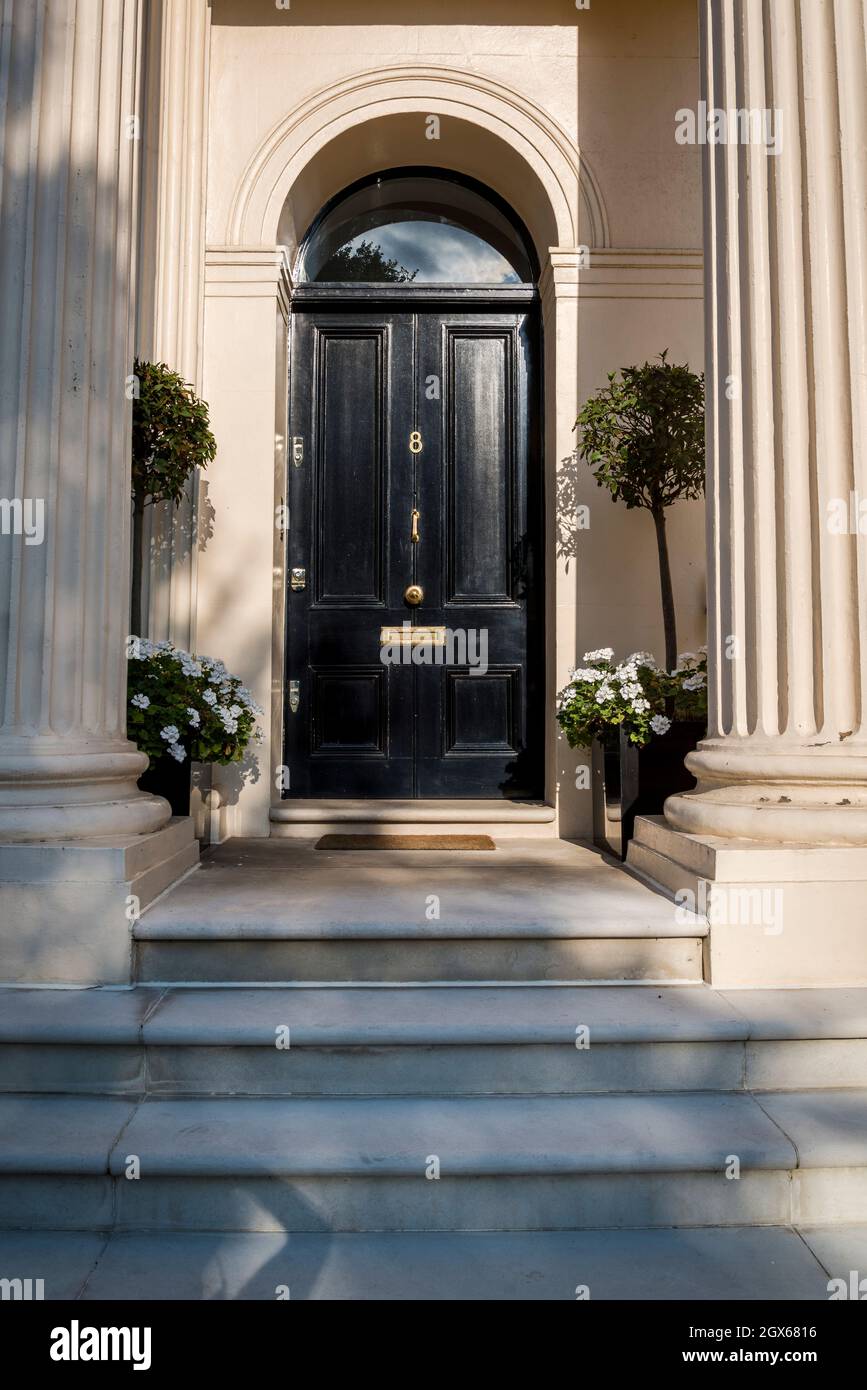 Detail of Neo-classical style entrance and portico with fluted ...