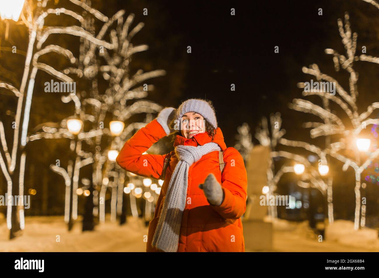 Girl having fun on christmas decoration lights street. Young happy ...