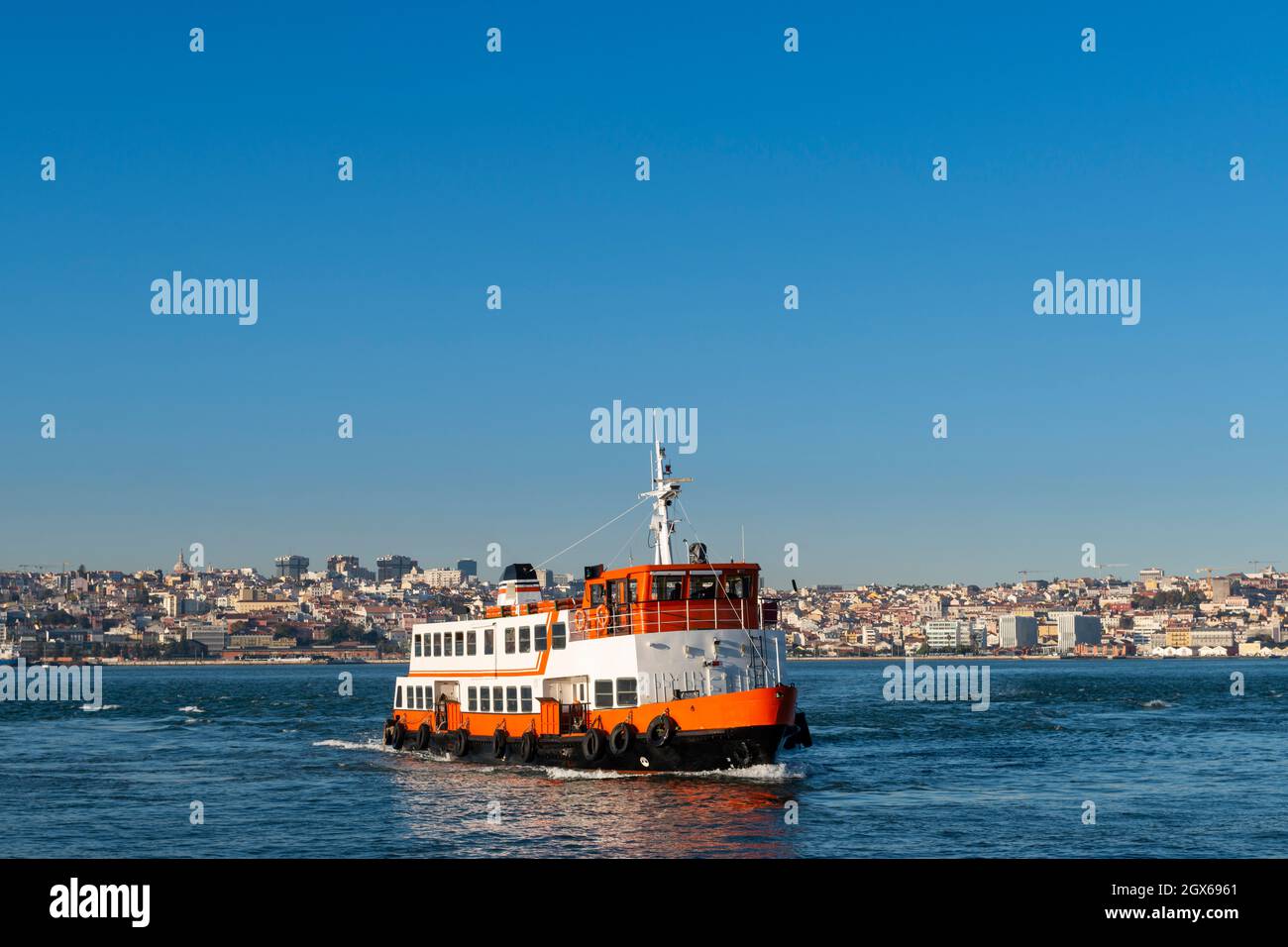 A traditional cacilheiro ferry boat crossing the Tagus River (Rio Tejo ...