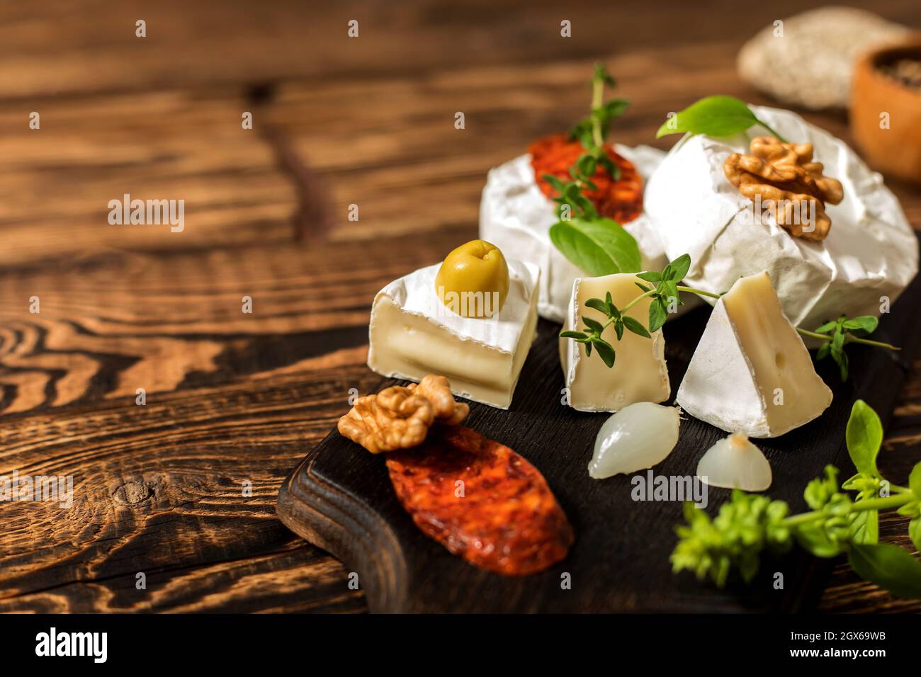 Camembert cheese on a rustic background. Noble cheese with mold. An ...