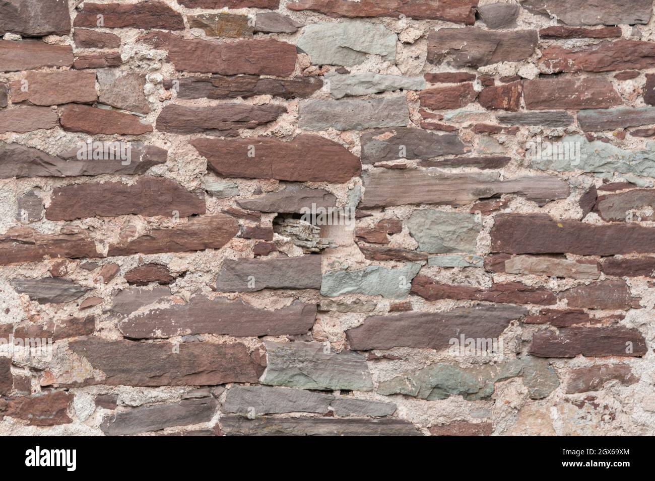 red stone wall. fragment of an ancient castle Stock Photo - Alamy