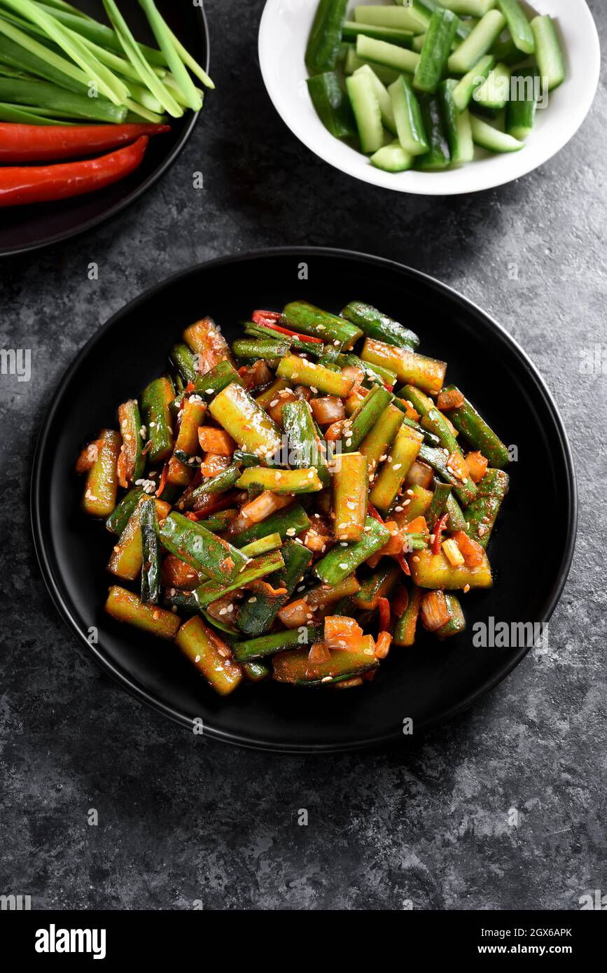 Korean style cucumber kimchi on plate over stone background Stock Photo ...