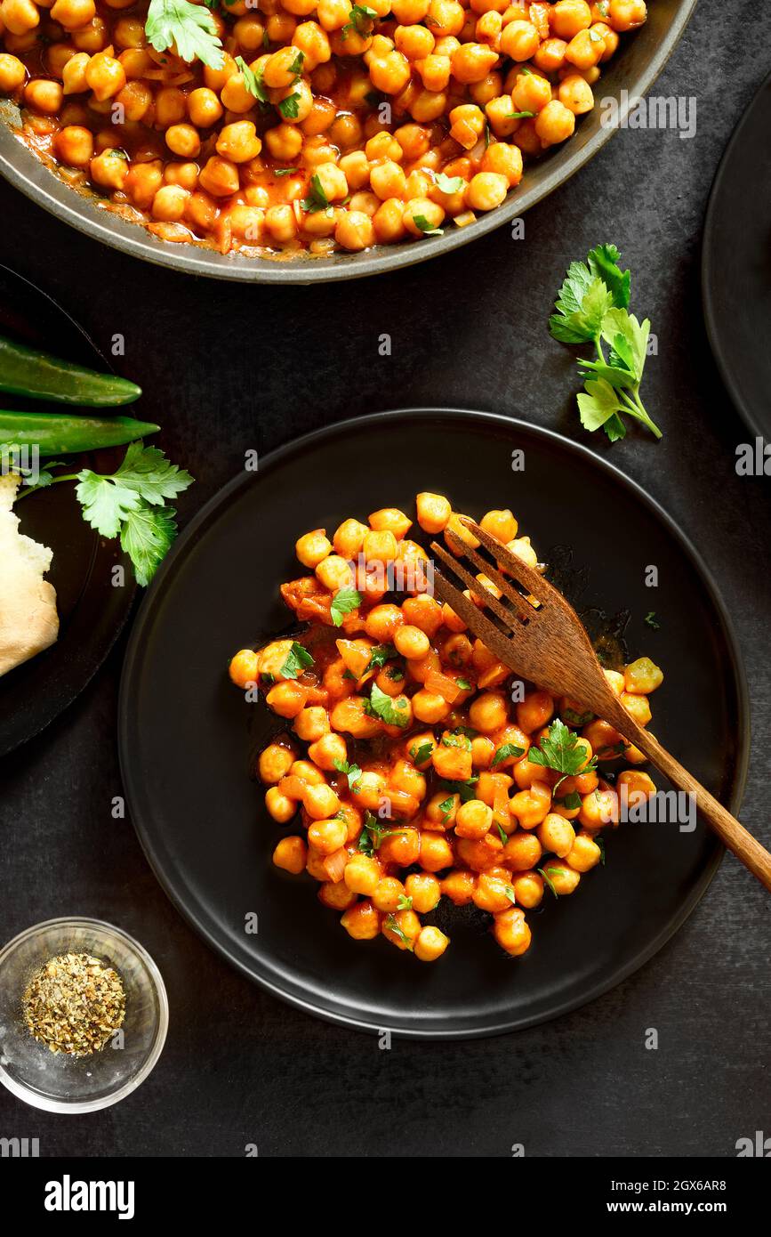 Indian style crispy roasted chickpeas over black stone background. Top ...