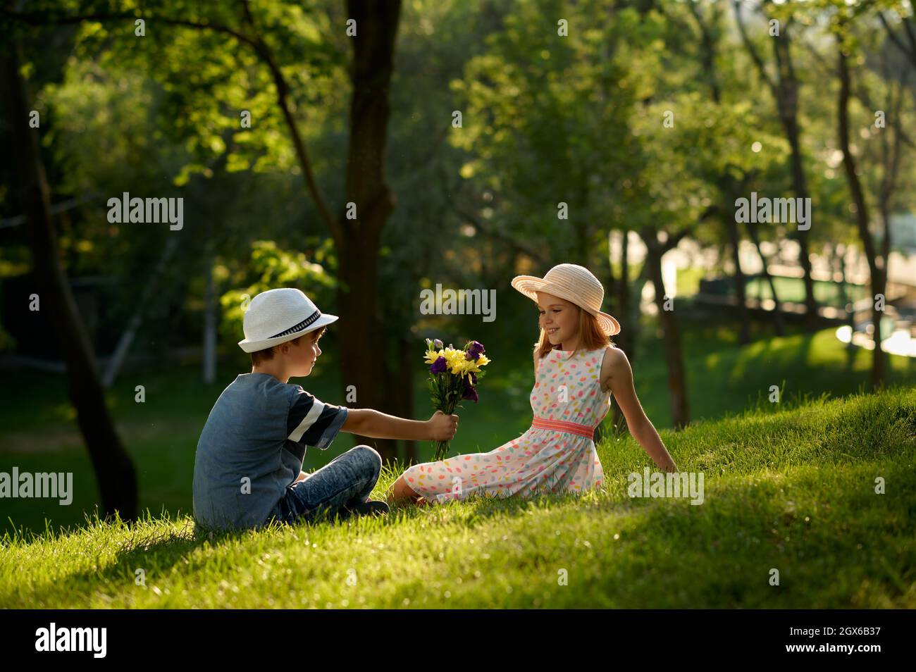 Children's date, boy gives bouquet to a girl Stock Photo - Alamy