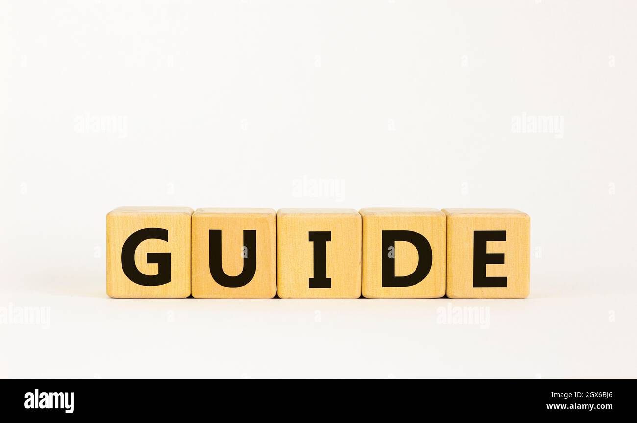 Guide and support symbol. The concept word 'guide' on wooden cubes on a ...