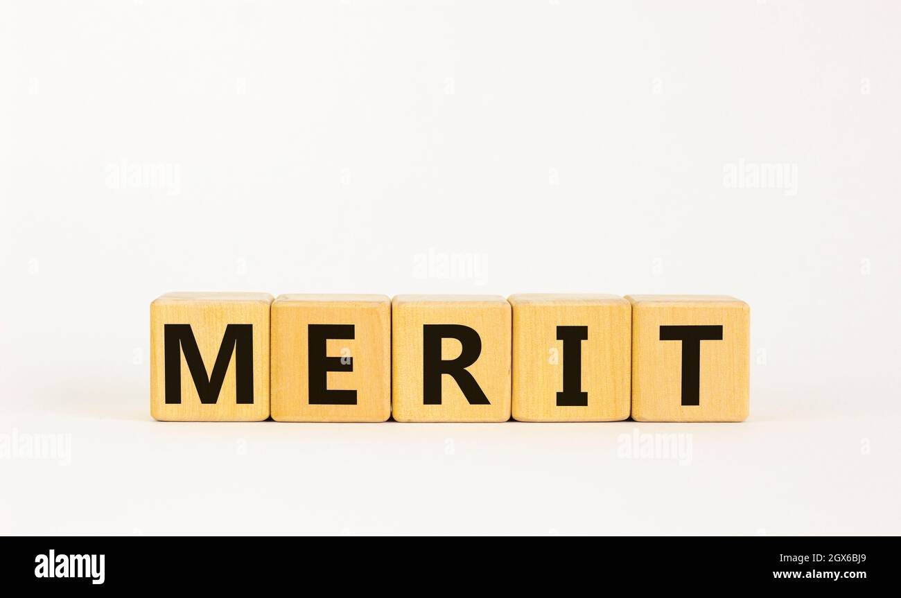 Merit symbol. The concept word 'merit' on wooden cubes on a beautiful ...