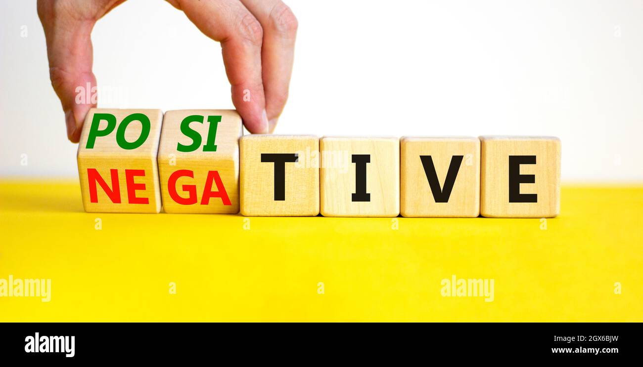 Positive or negative symbol. Businessman turns wooden cubes and changes ...