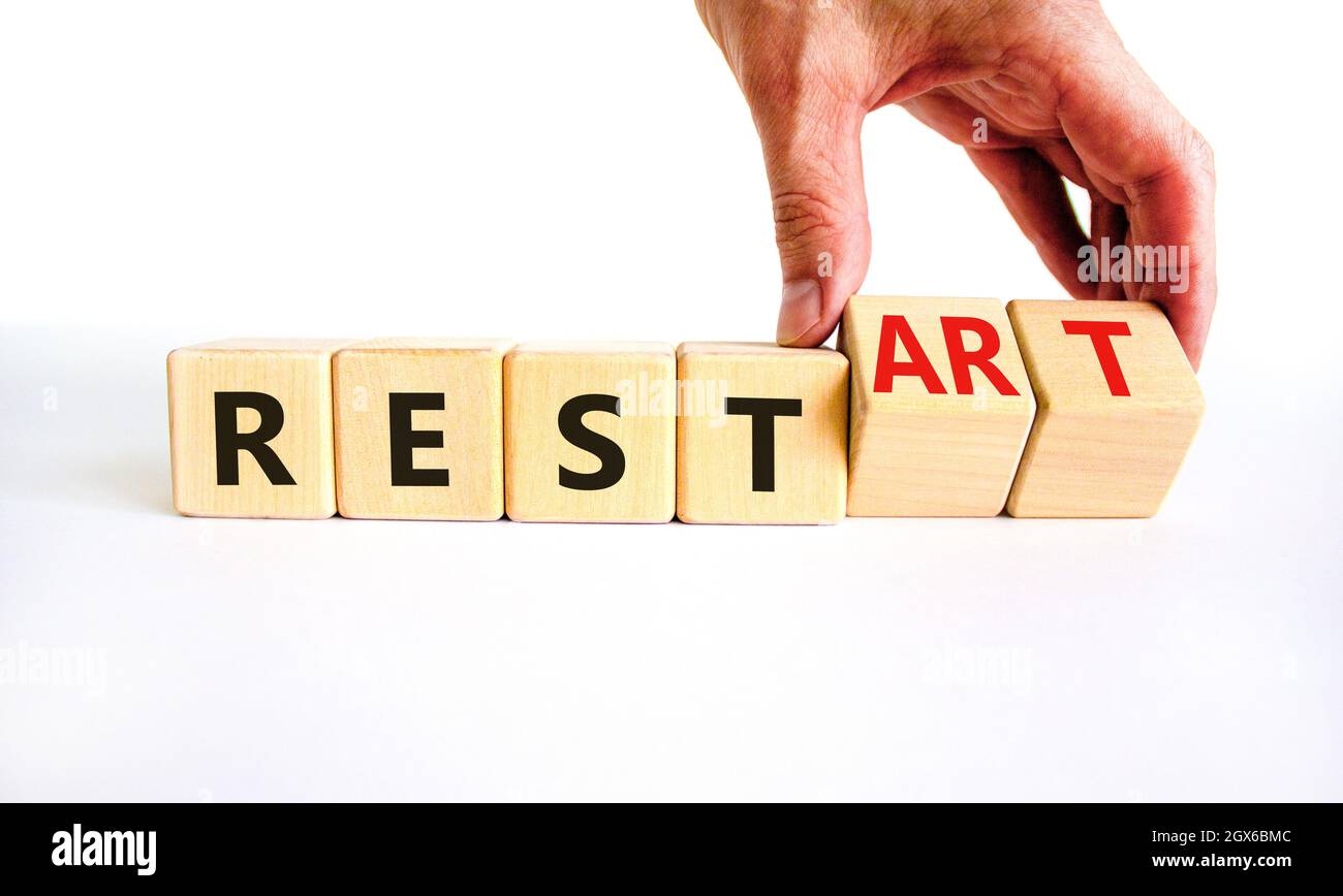 Rest and restart symbol. Businessman turns wooden cubes and changes the ...