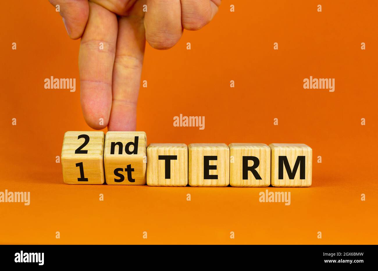 First or second term symbol. Businessman turns wooden cubes and changes ...