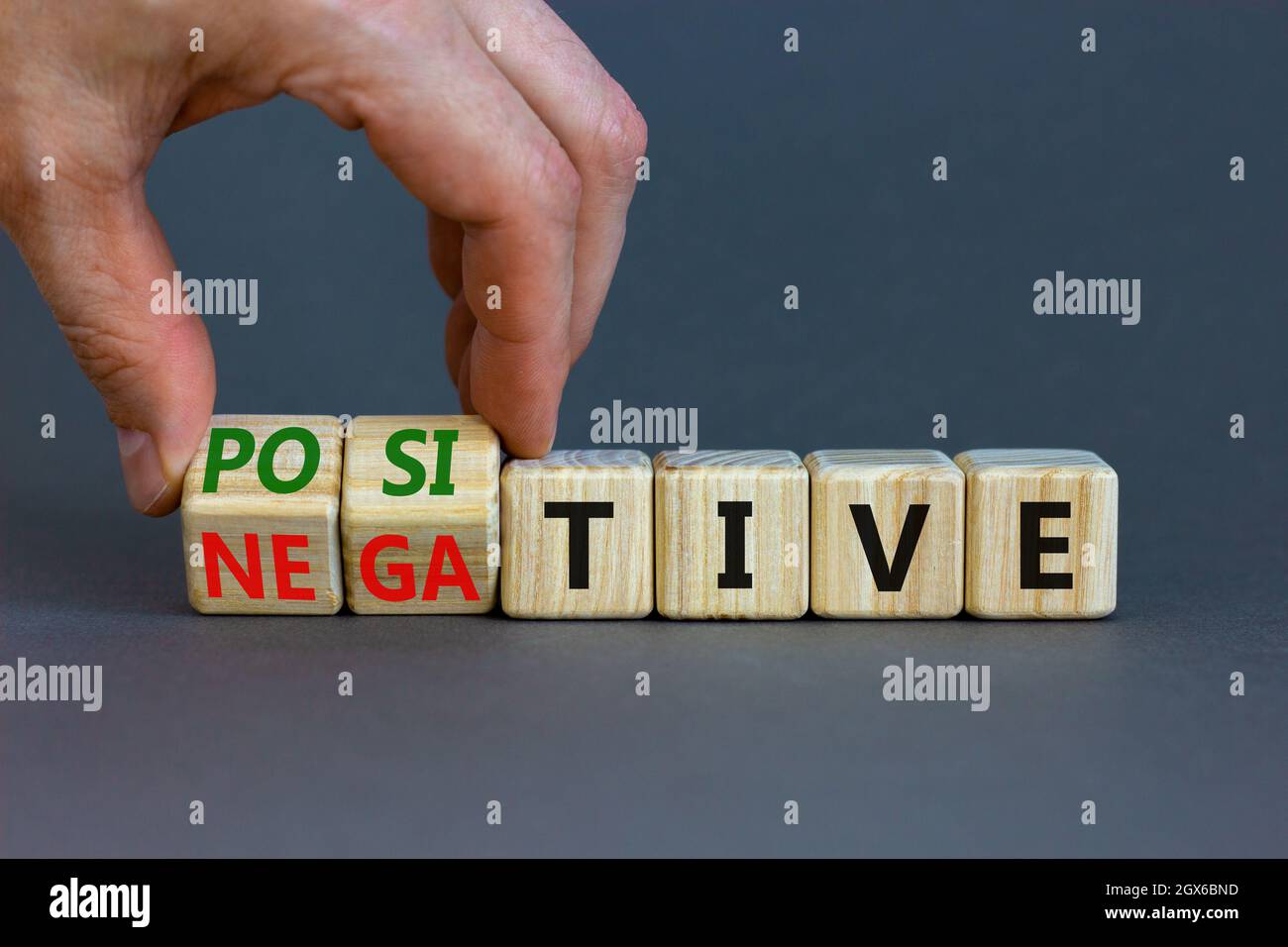 Positive or negative symbol. Businessman turns wooden cubes and changes ...