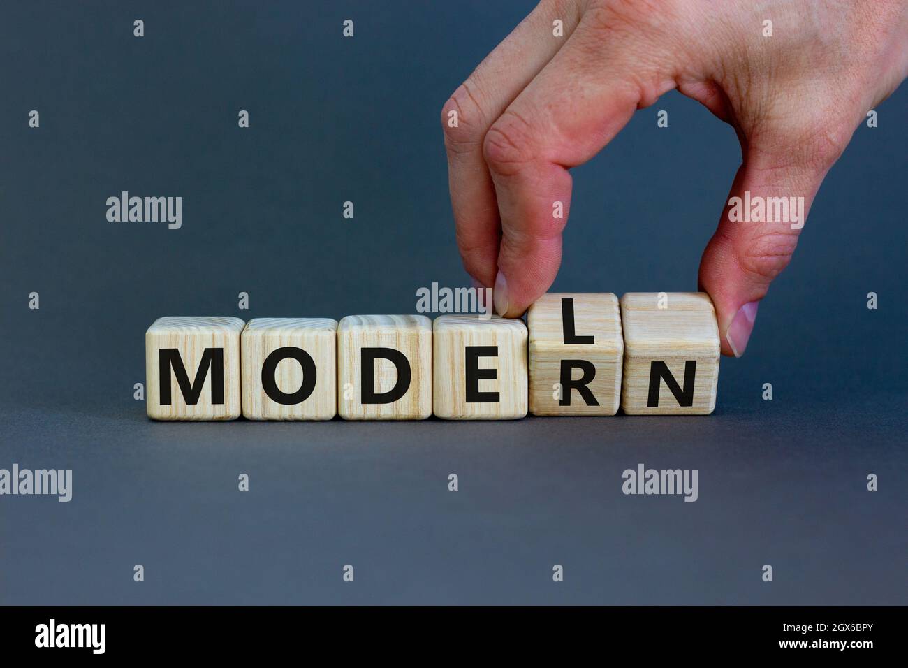 Modern model symbol. Businessman turns wooden cubes and changes the ...