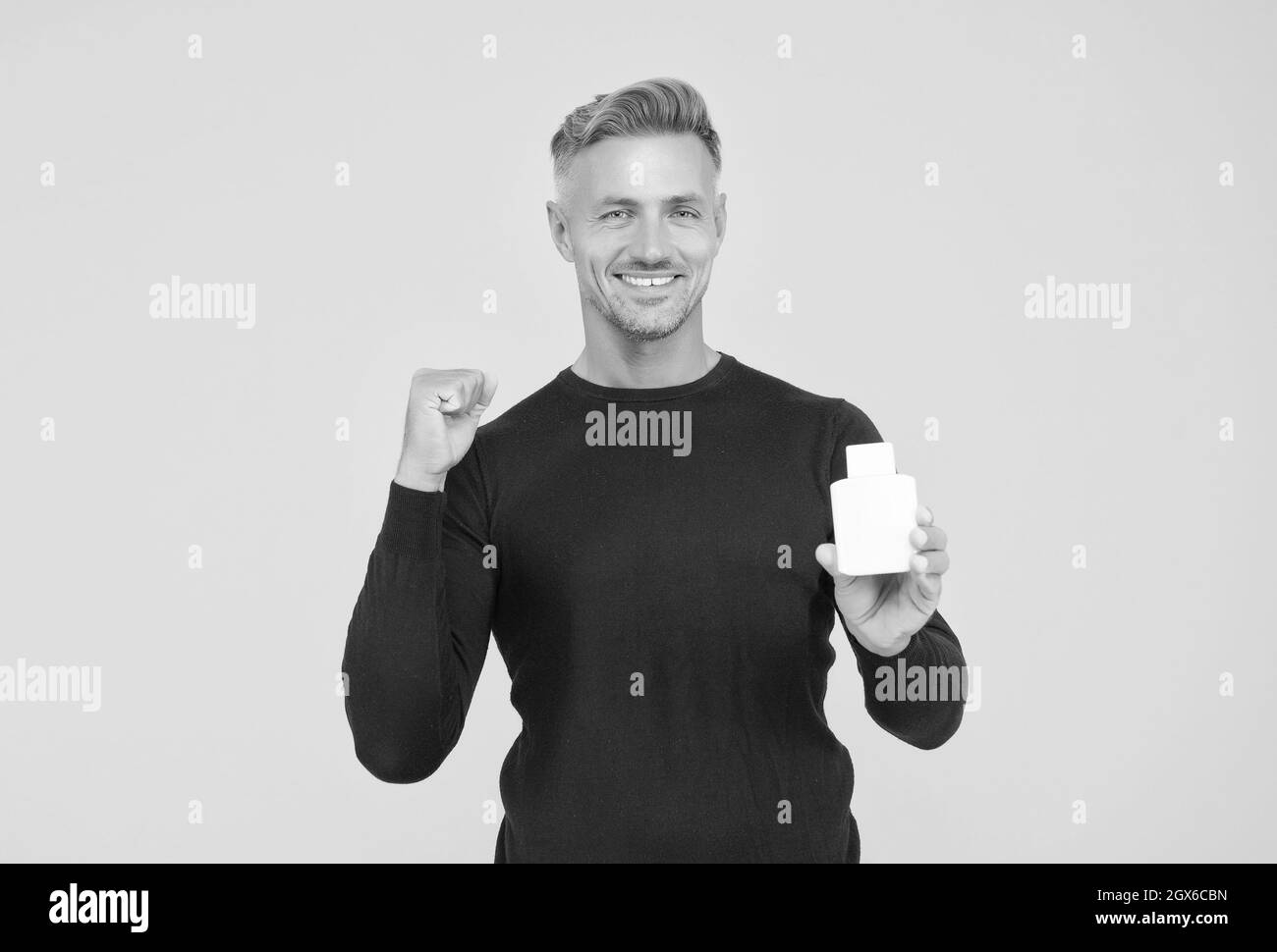 Confident about the way he looks. Confident guy present cologne ...