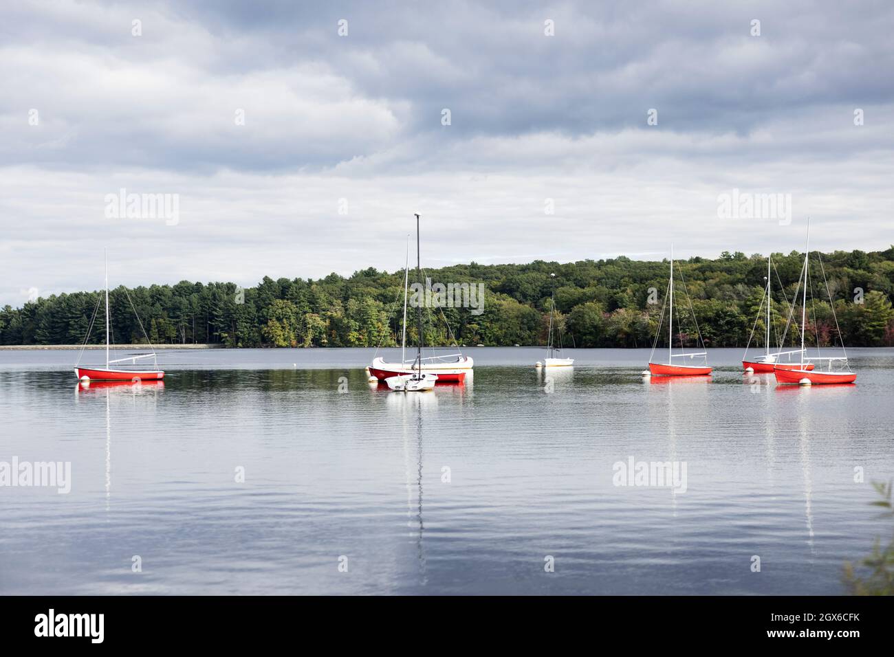 Red sailboats on the reservoir on a cloudy fall day at Hopkinton State ...