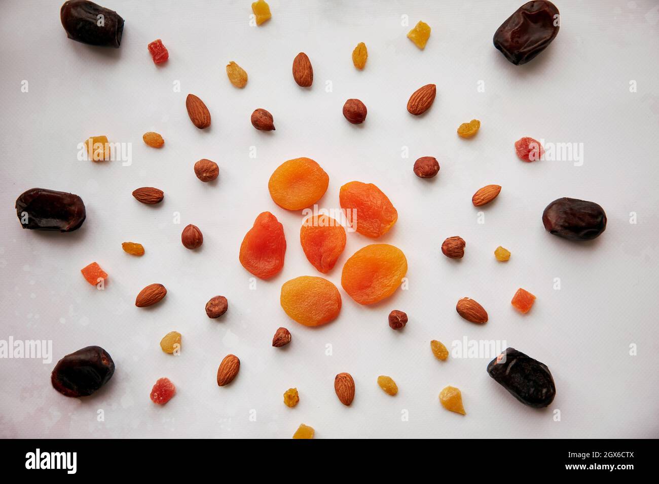 Creative food in shape of sun with dates, dried apricots, hazelnuts ...
