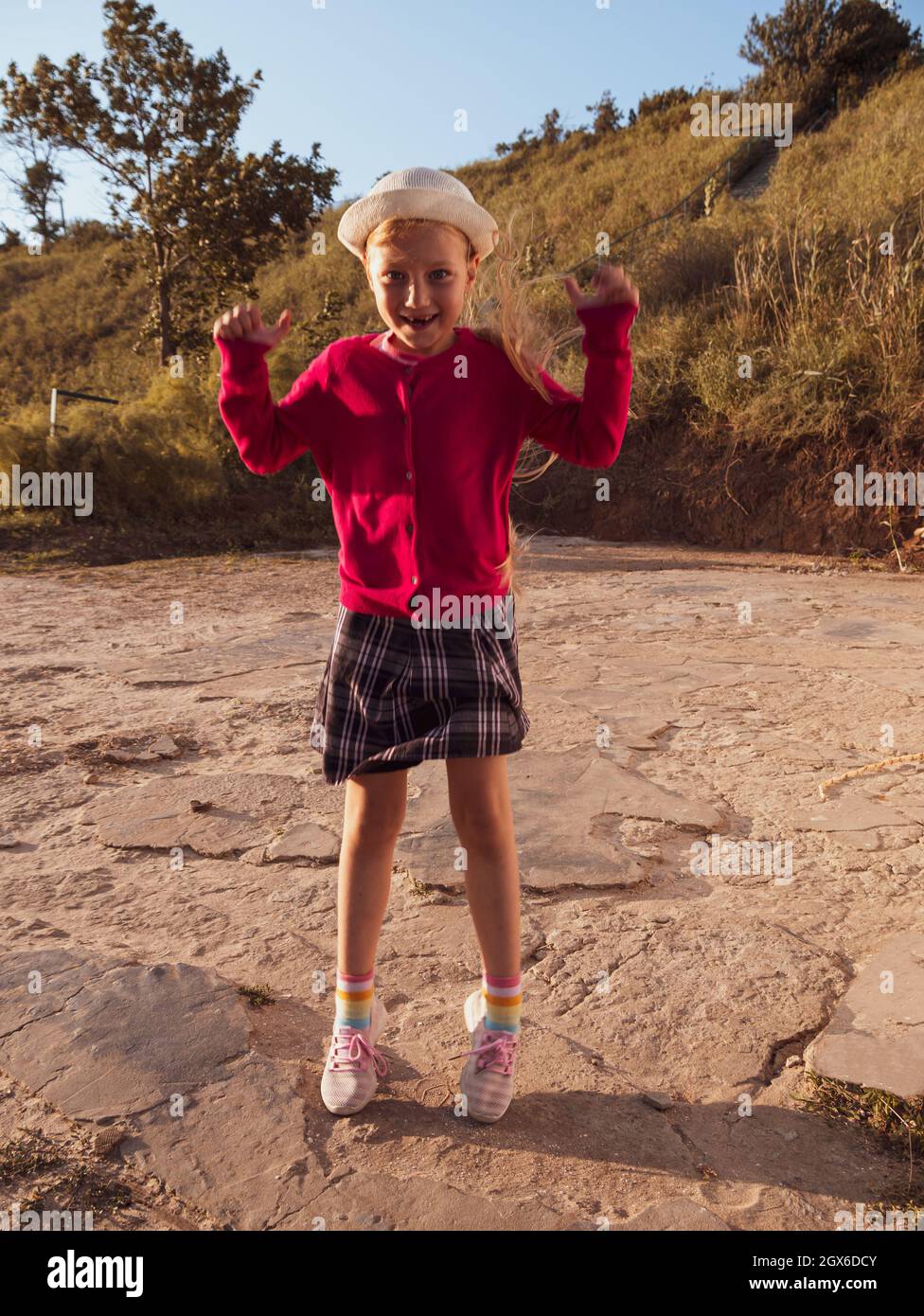 Happy little girl with long hair portrait jumping on nature background ...