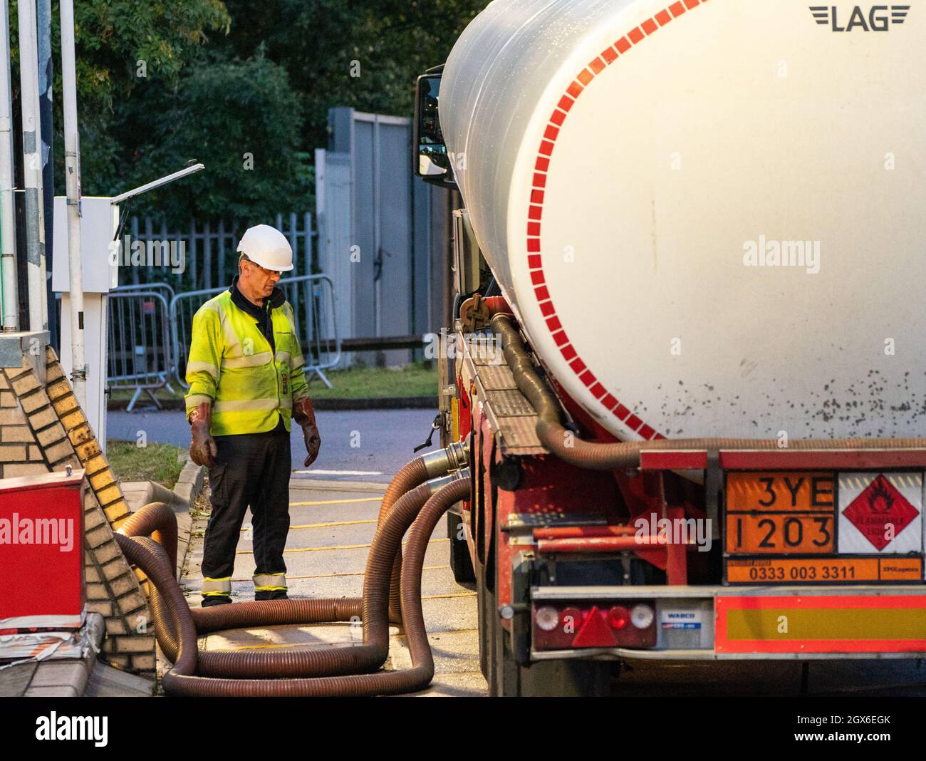 A tanker driver makes a fuel delivery at a petrol station in south ...