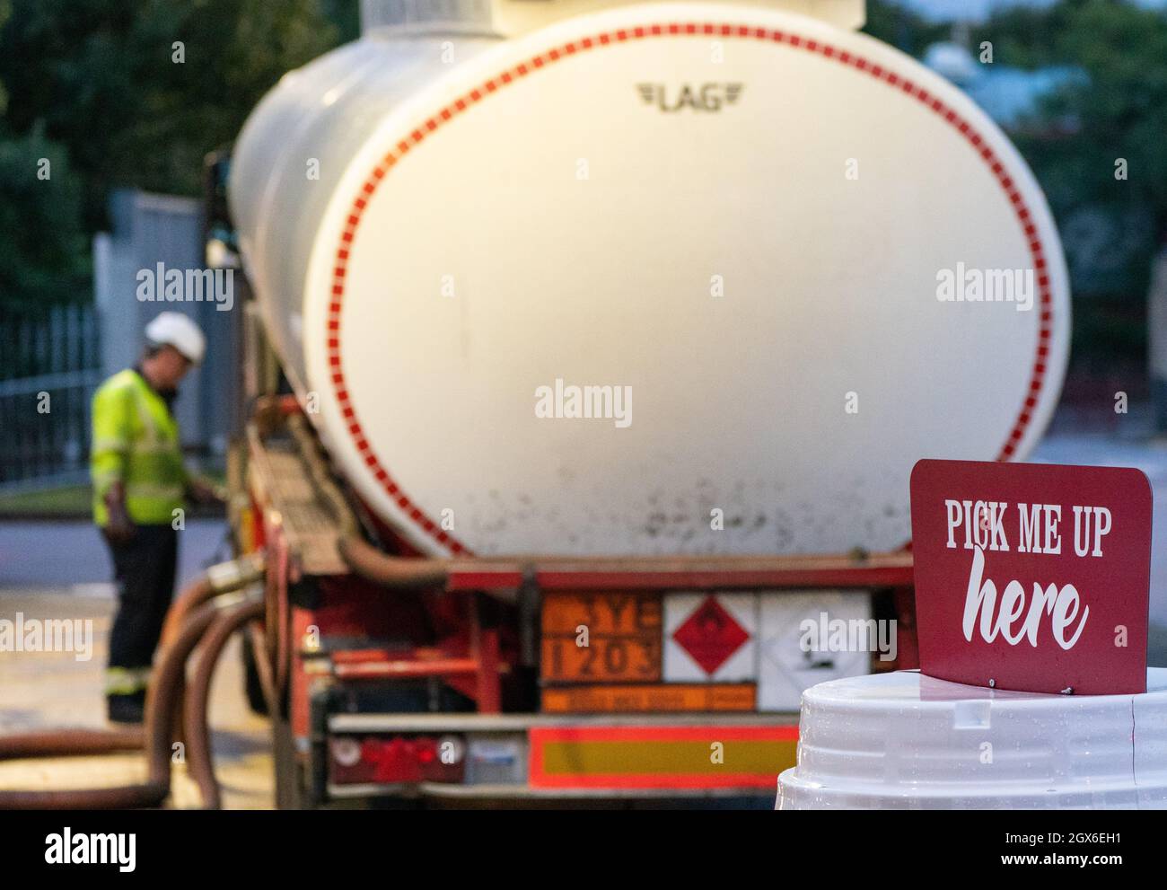 A tanker driver makes a fuel delivery at a petrol station in south ...