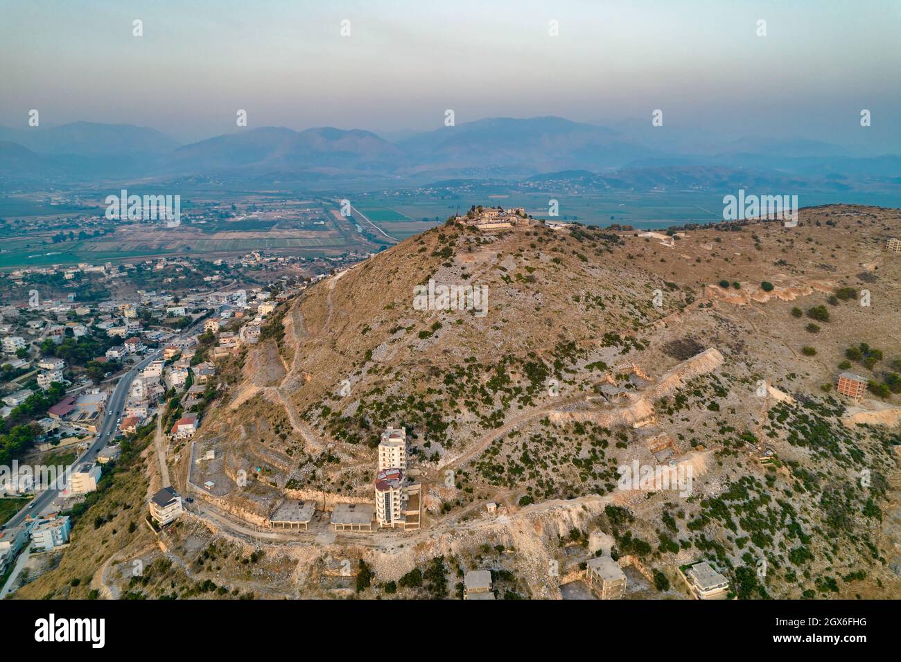 Aerial sunset drone view of Saranda city and Lekursi Castle with ...