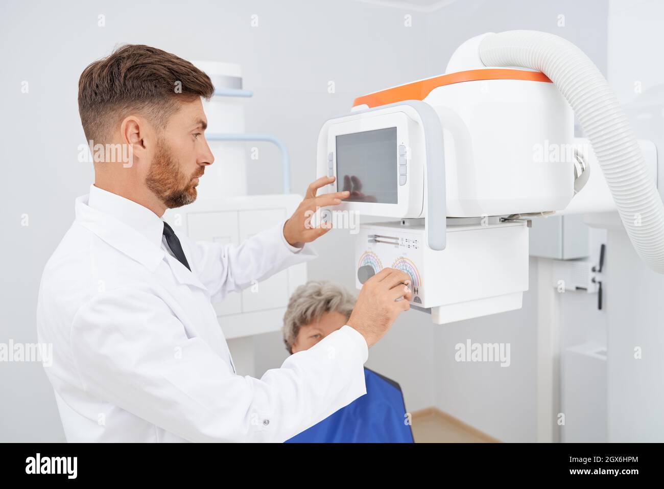 Handsome brunette radiologist using and touching screen of ultrasound ...