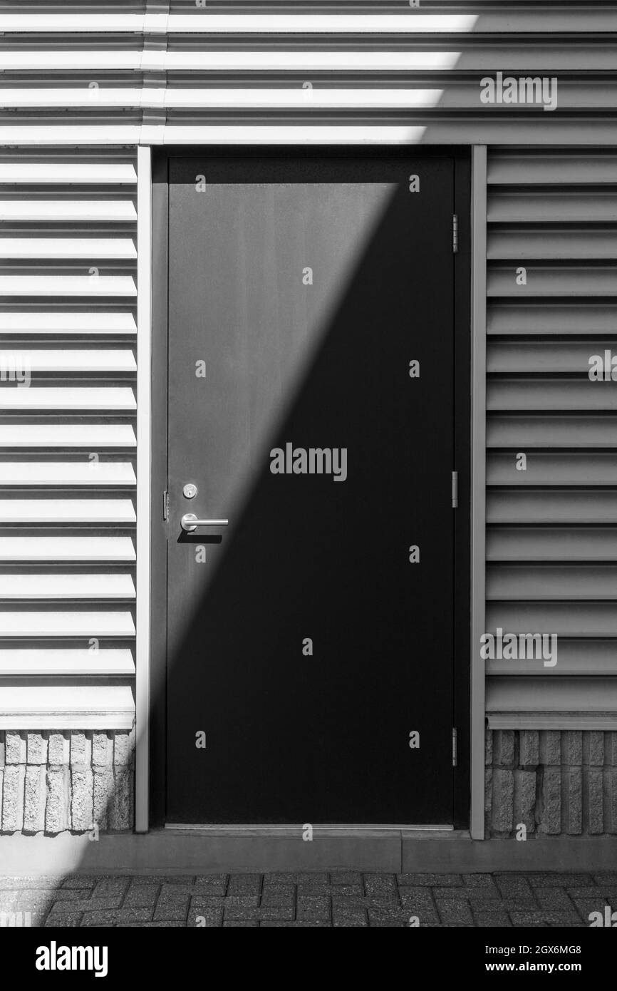 Sunlight and shadow on surface of black door of urban building Stock ...