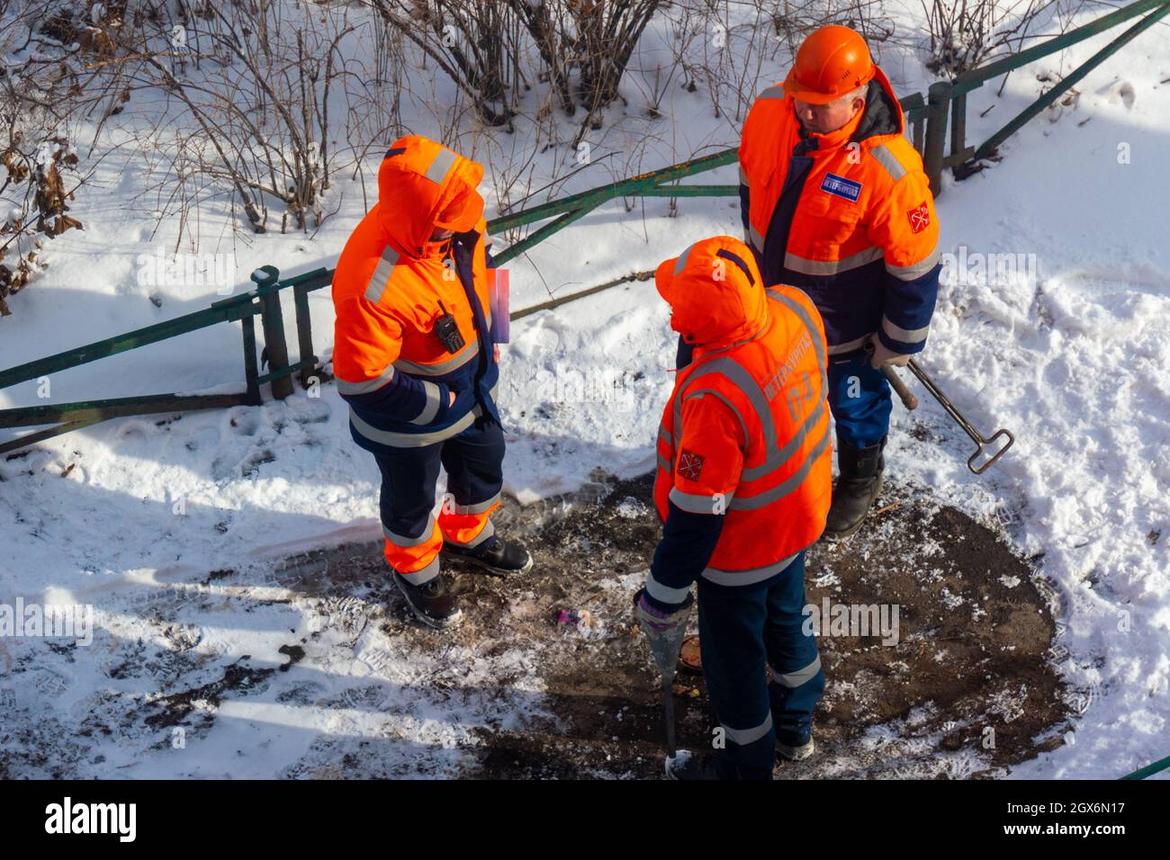 gas service workers check underground utilities. gas workers pour ...