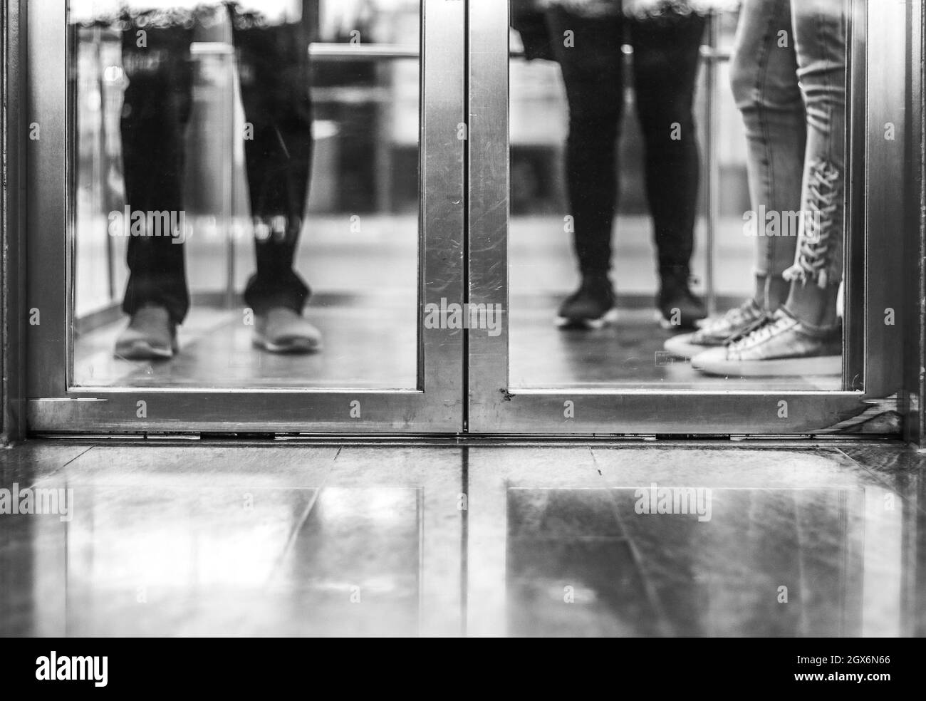 Businessman standing behind glass Black and White Stock Photos & Images ...