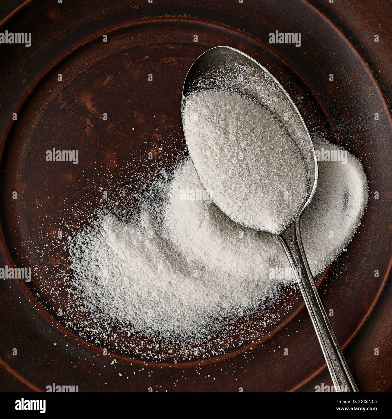 collagen powder on iron spoon on a clay plate. youthfulness and ...