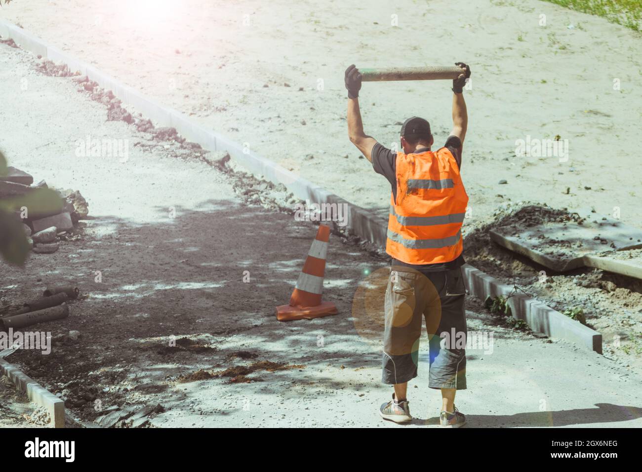 A construction worker hits a pipe on the ground while repairing a road ...
