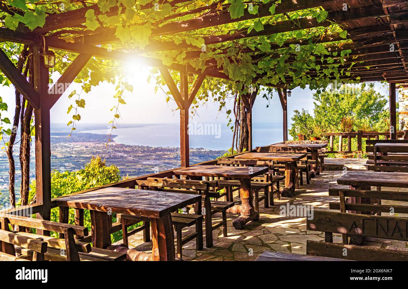 Greek ethnic restaurant terrace covered with grapes, overlooking the ...
