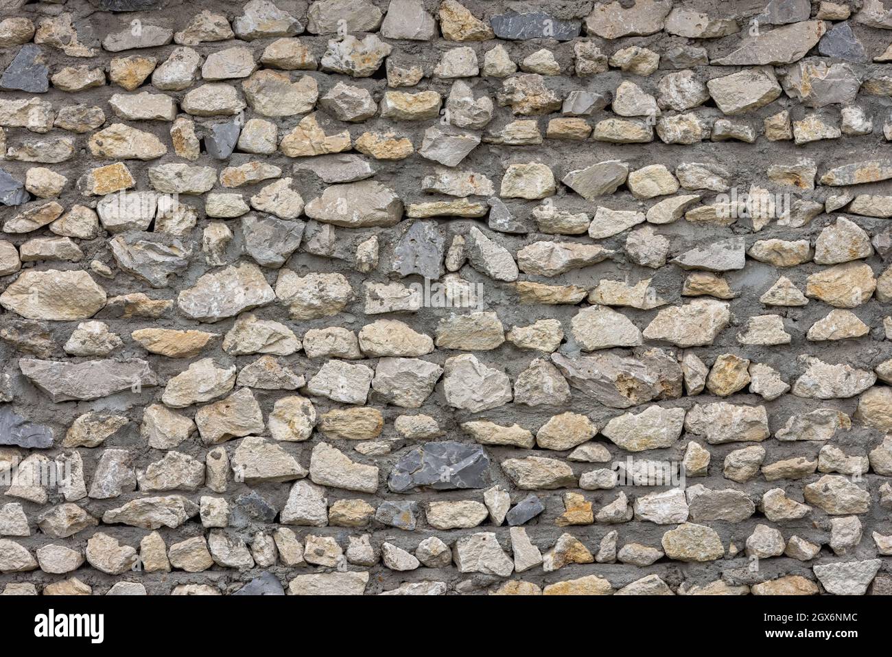 full frame background and texture of ugly sharp stone wall with ...