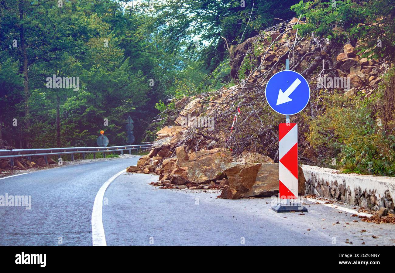 rockfall on the road, stones collapse. warning sign Stock Photo - Alamy