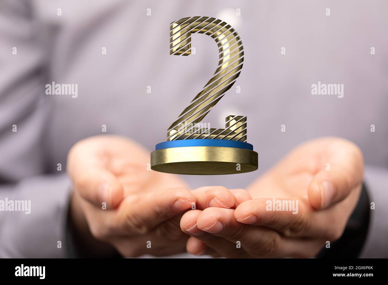 A 3D rendering of a number two trophy on a man's palms Stock Photo - Alamy