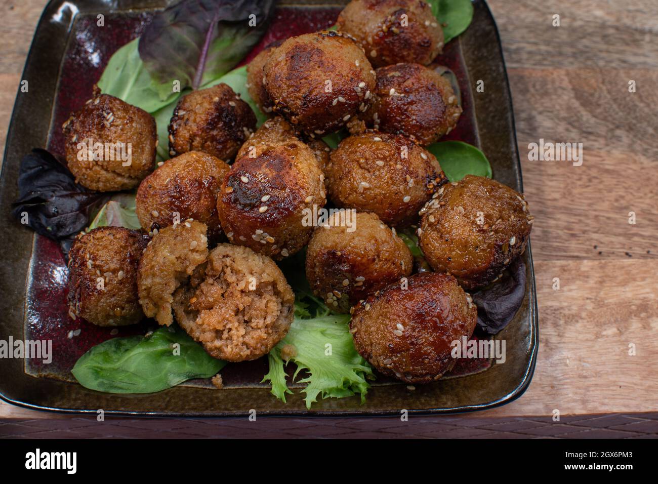 Seitan vegan meatballs tsukune style with tare sauce Stock Photo - Alamy