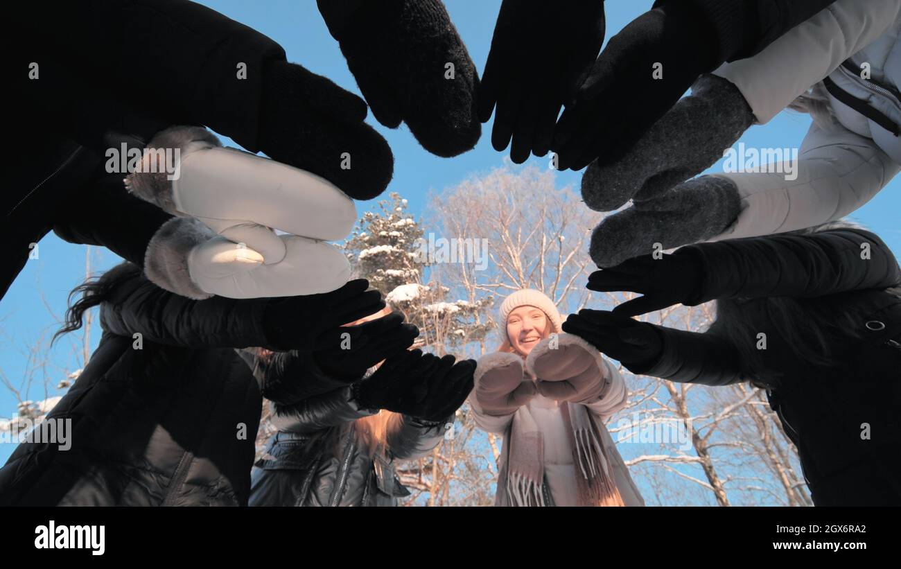 Friends on a winter day join their hands with mittens in a circle Stock ...