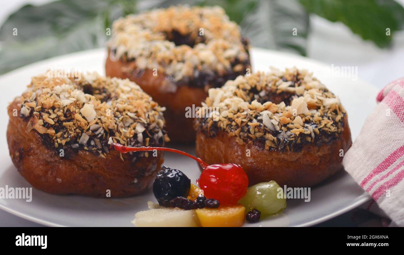 Two Chocolate Donuts in front and two in back. with Toasted Coconut ...