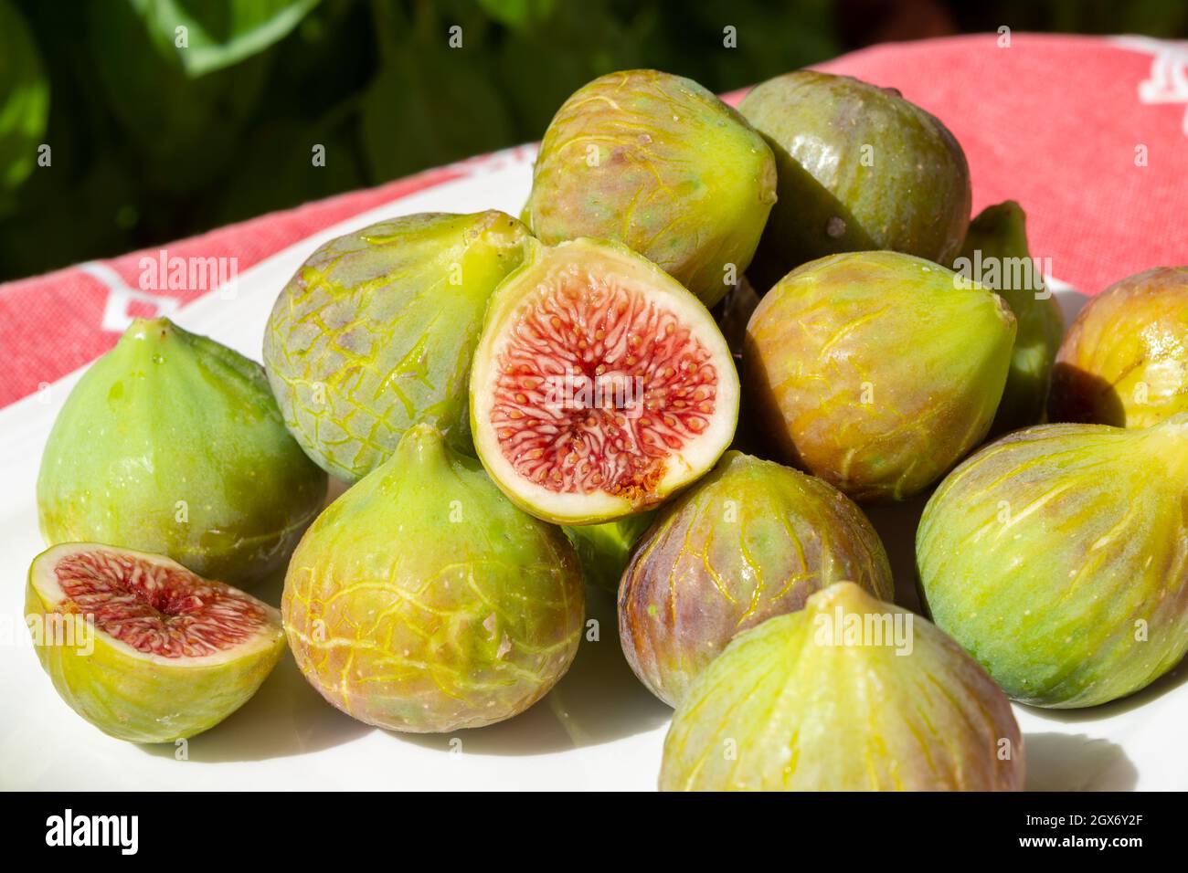 New harvest of fresh ripe sweet fig fruits on white plate Stock Photo ...