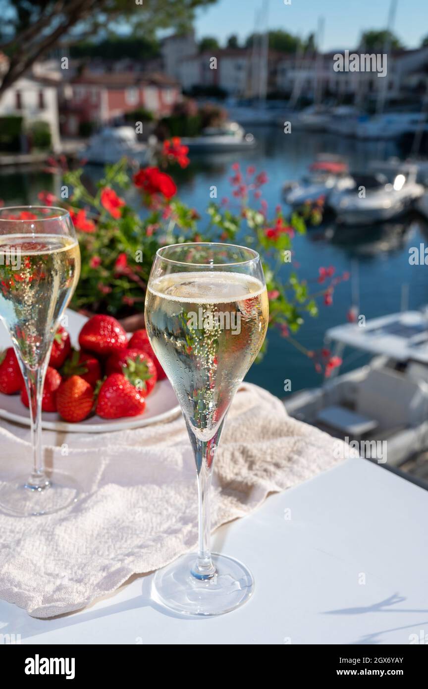 Summer party, pouring of French brut champagne sparkling wine in ...