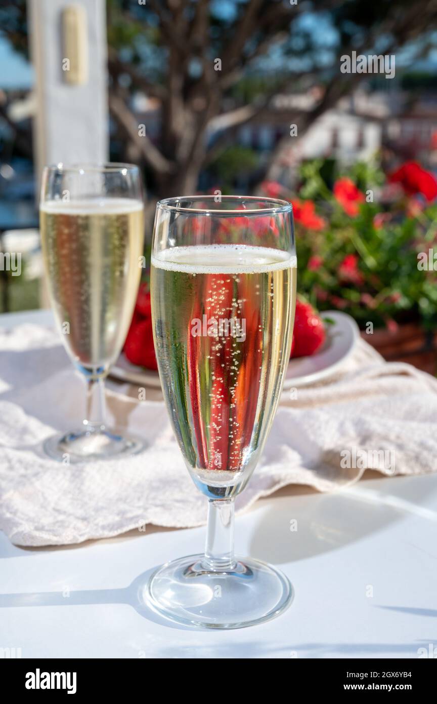 Summer party, pouring of French brut champagne sparkling wine in ...