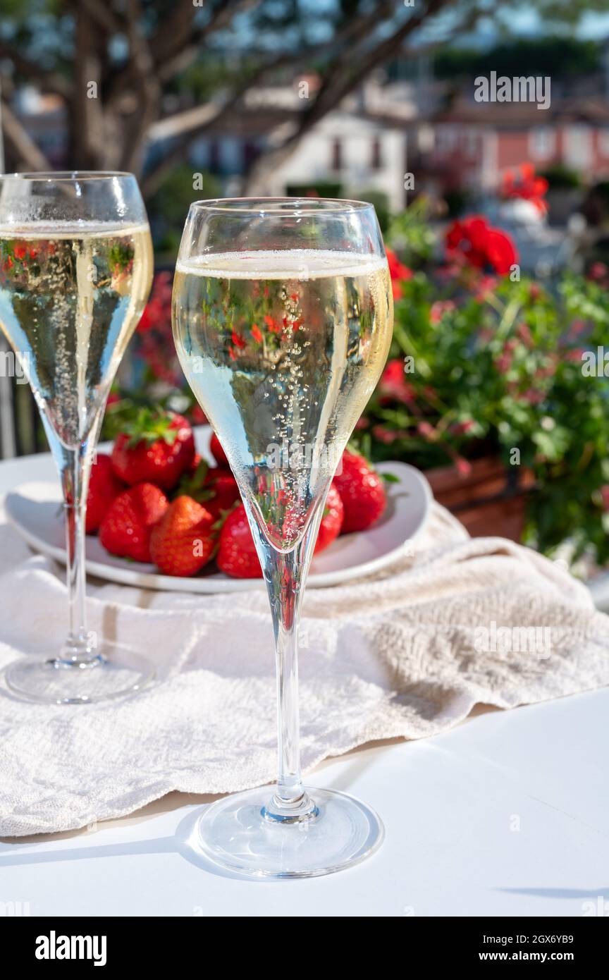 Summer party, pouring of French brut champagne sparkling wine in ...