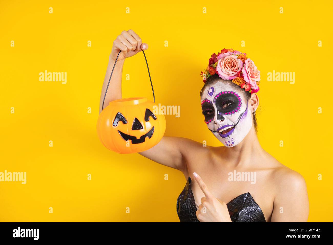 Mexican Catrina, portrait of young latin woman holding a plastic ...